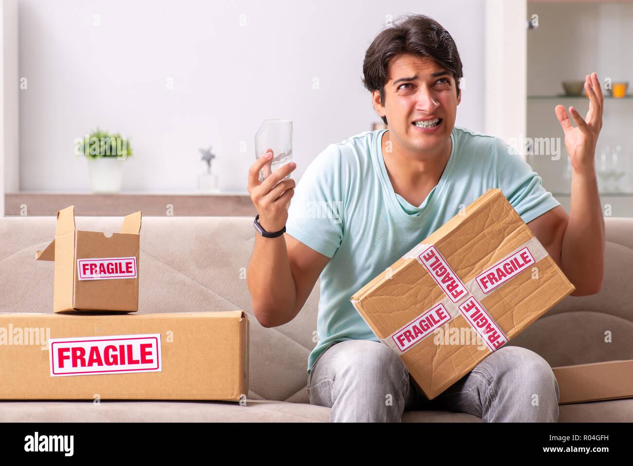 Man opening fragile parcel ordered from internet Stock Photo - Alamy