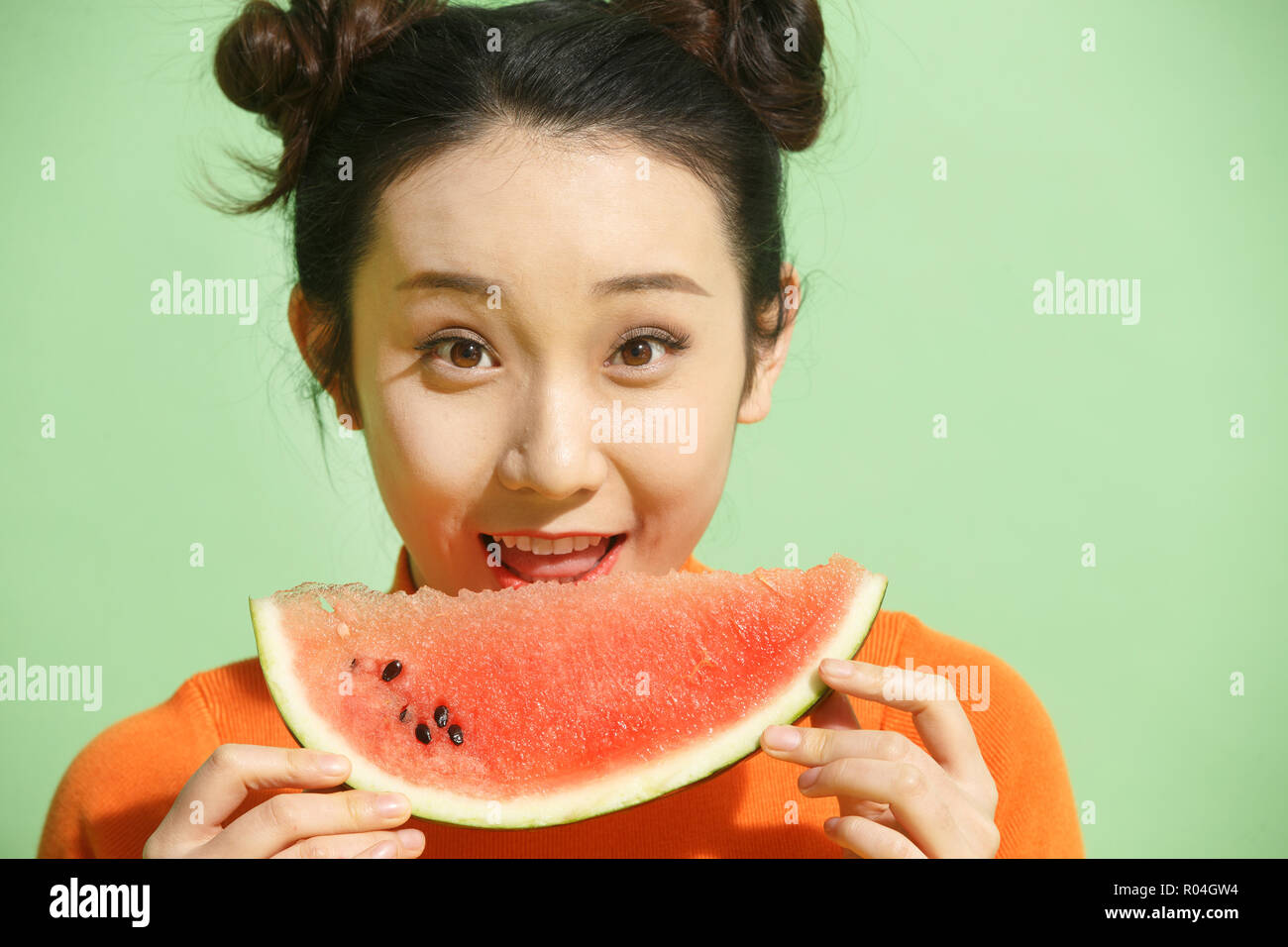 Young women eat watermelon Stock Photo - Alamy