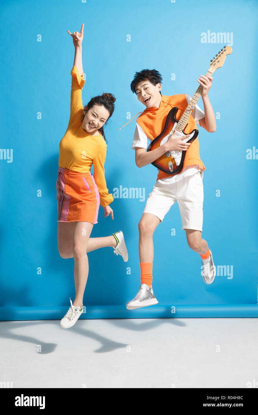 Young couples to play guitar and dance Stock Photo - Alamy