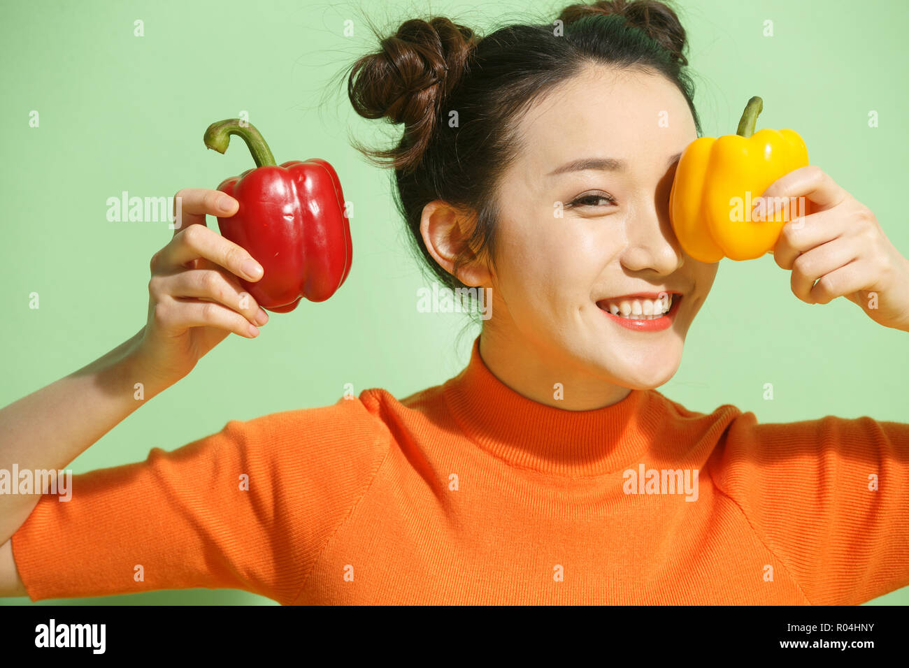 Young women with chili peppers Stock Photo - Alamy