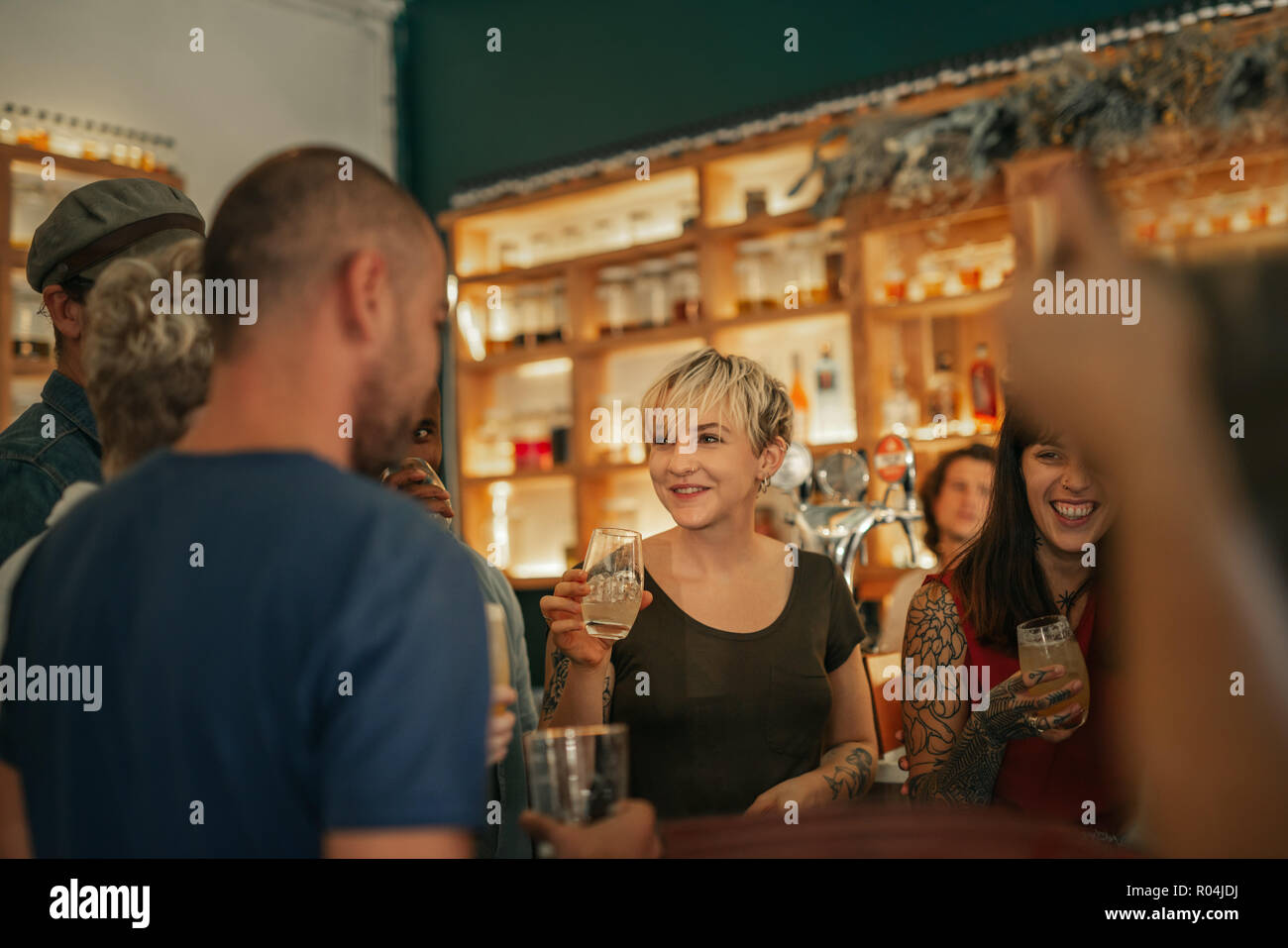 Smiling group of friends having drinks together in a bar Stock Photo ...