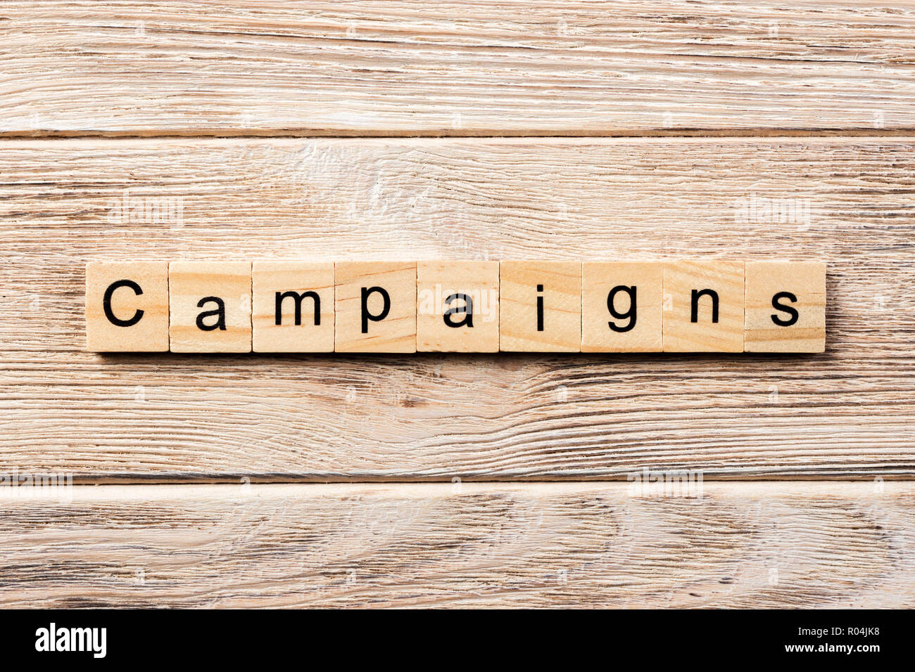 campaign word written on wood block. campaign text on table, concept ...