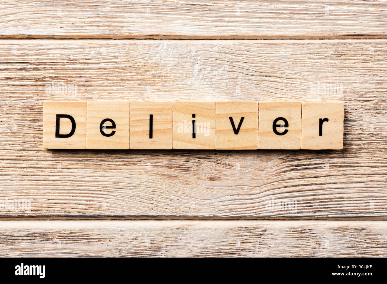 deliver word written on wood block. deliver text on table, concept ...