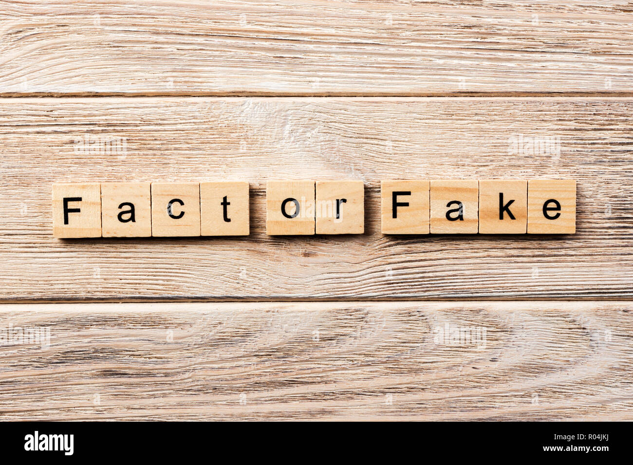 fact or fake word written on wood block. fact or fake text on table ...