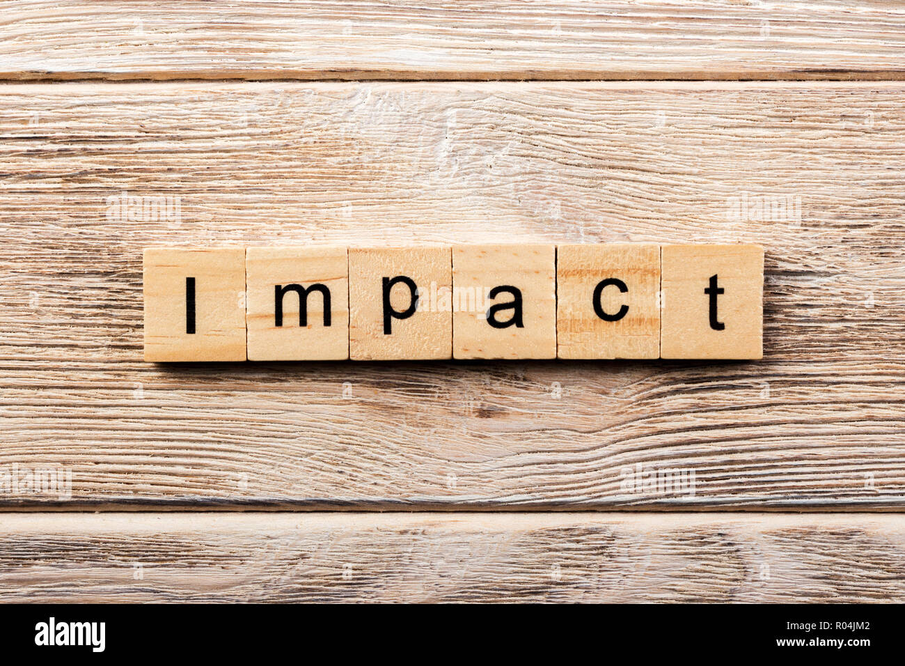 impact word written on wood block. impact text on table, concept Stock ...