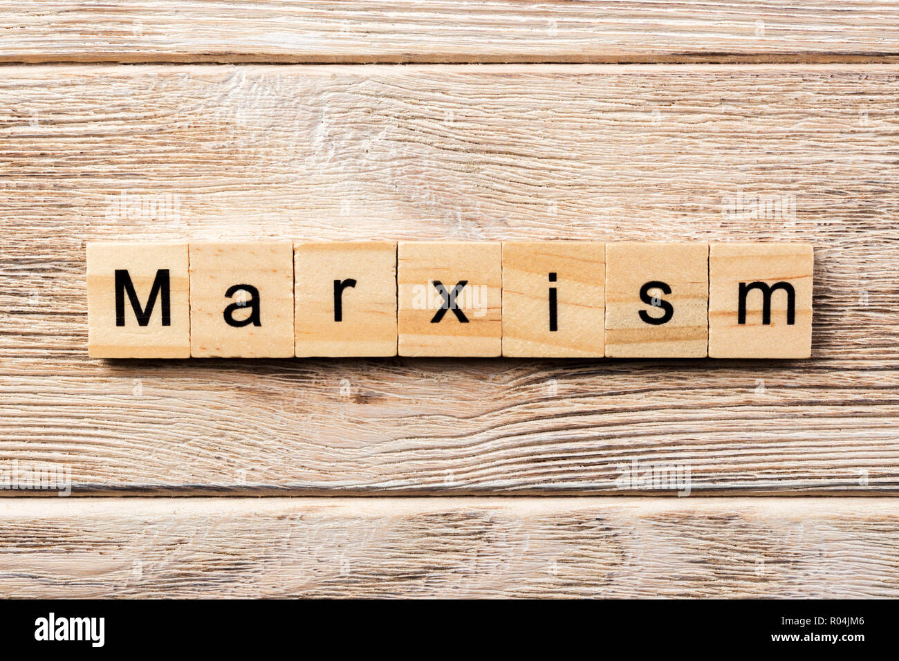 marxism word written on wood block. marxism text on table, concept ...