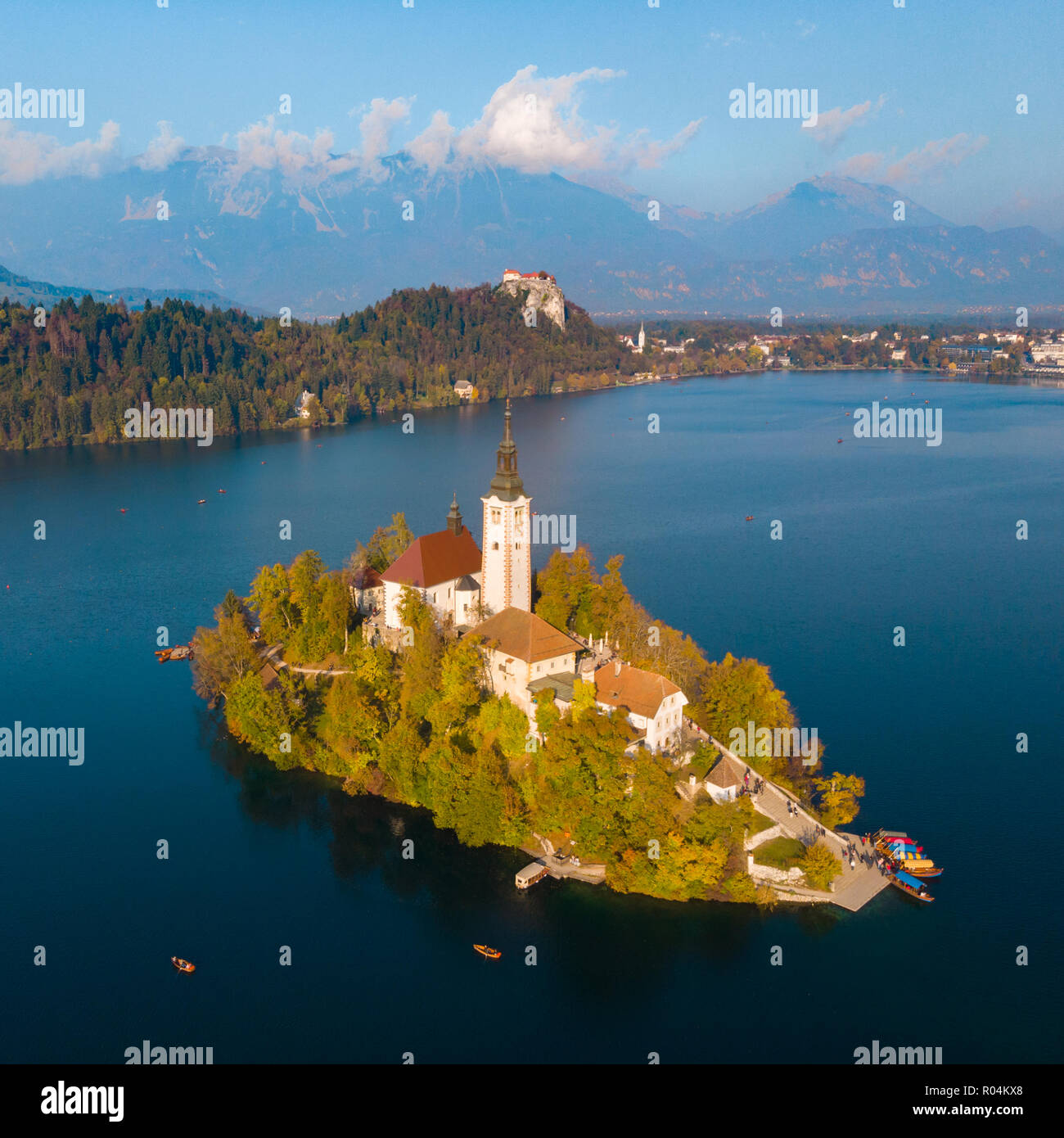 Aerial view of Bled island on lake Bled, and Bled castle and mountains ...