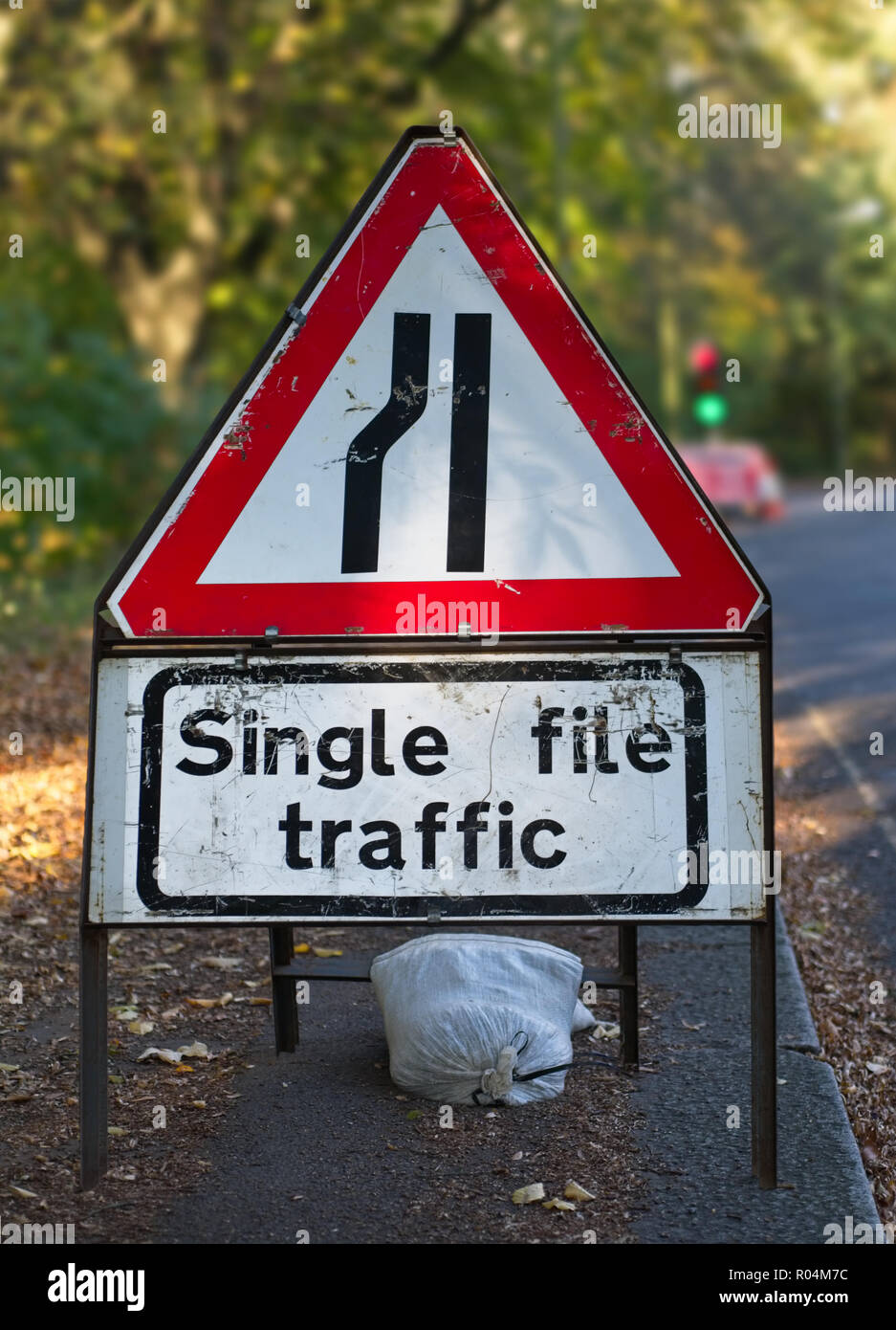 UK road sign: Single file traffic and Road Narrows Left Stock Photo - Alamy