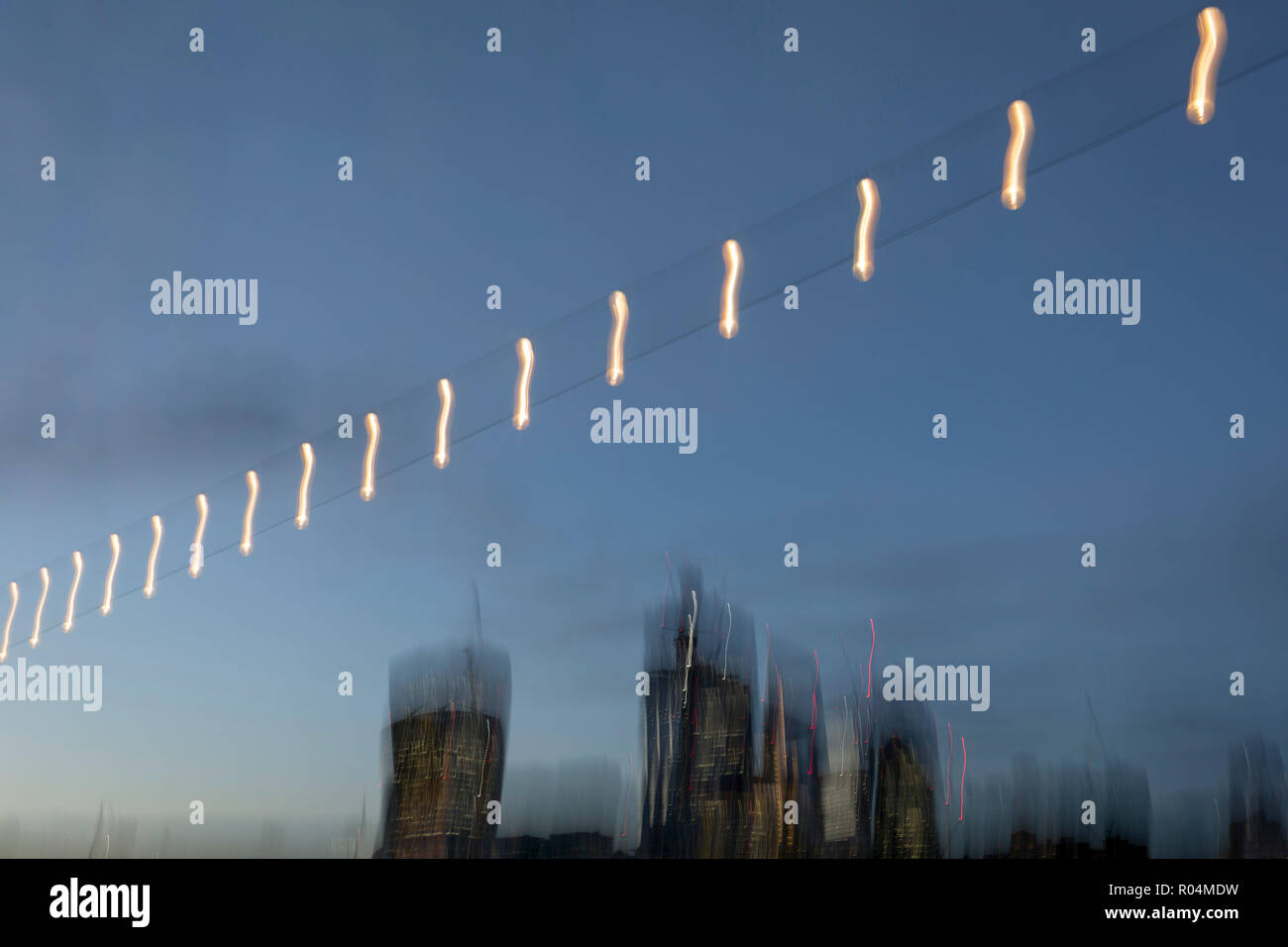 Blurred overhead lights on the Southbank and the skyline of the City of ...