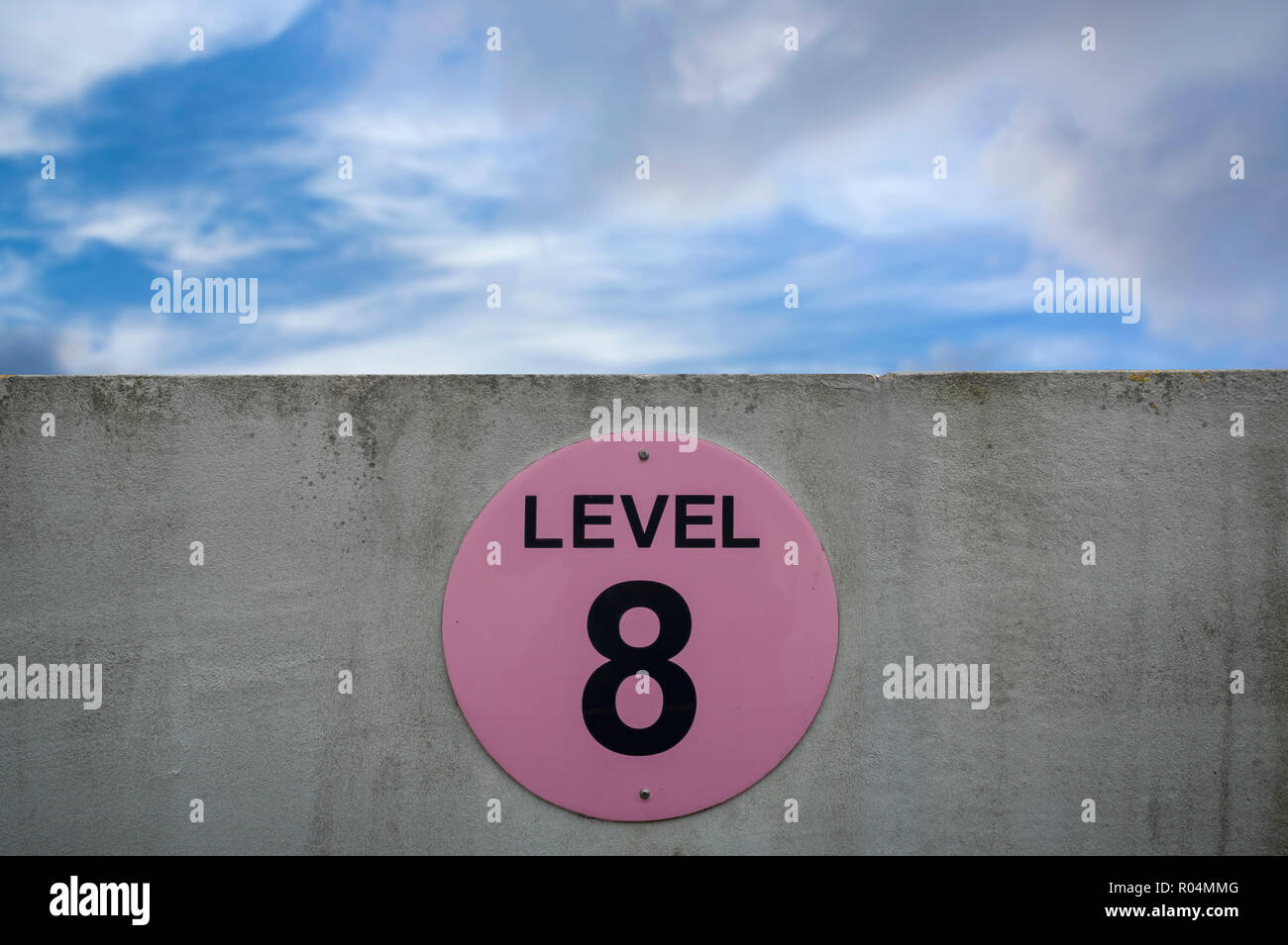 Level 8 sign on a concrete wall with a blue sky Stock Photo - Alamy