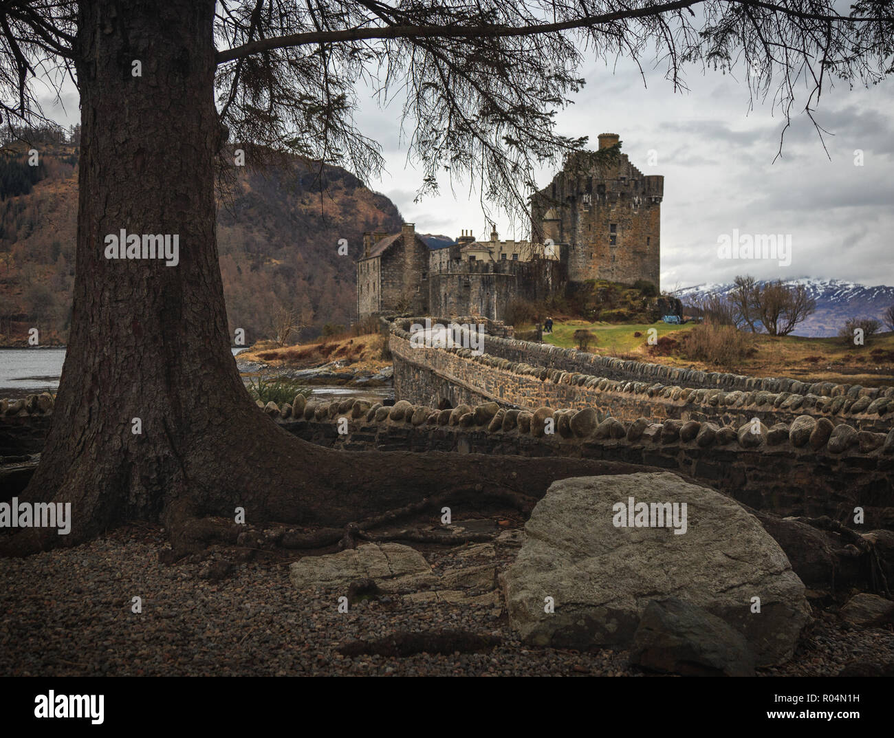 Eilean Donan castle on the shore of Lock Duich in cloudy day. Medieval ...