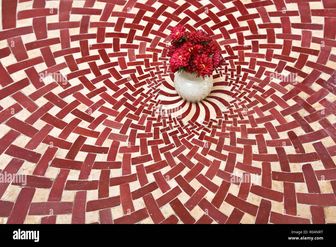 Red lattice patterned Moroccan table top with red flowers, Chefchaouen ...