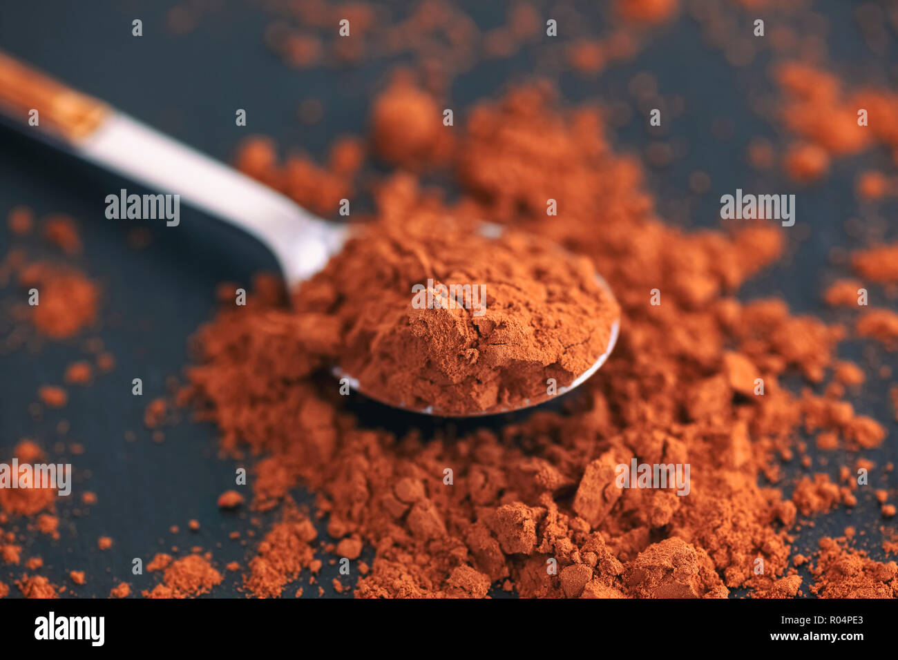 Spoon filled with organic cocoa powder. Close up Stock Photo - Alamy