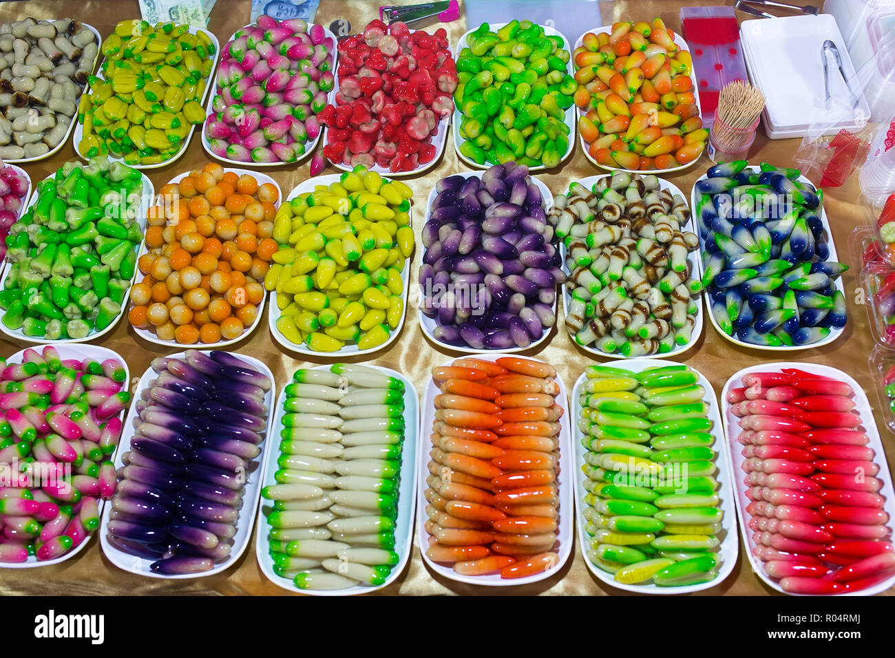 Colorful Thai candies made from peanuts and jelly displayed on a street ...