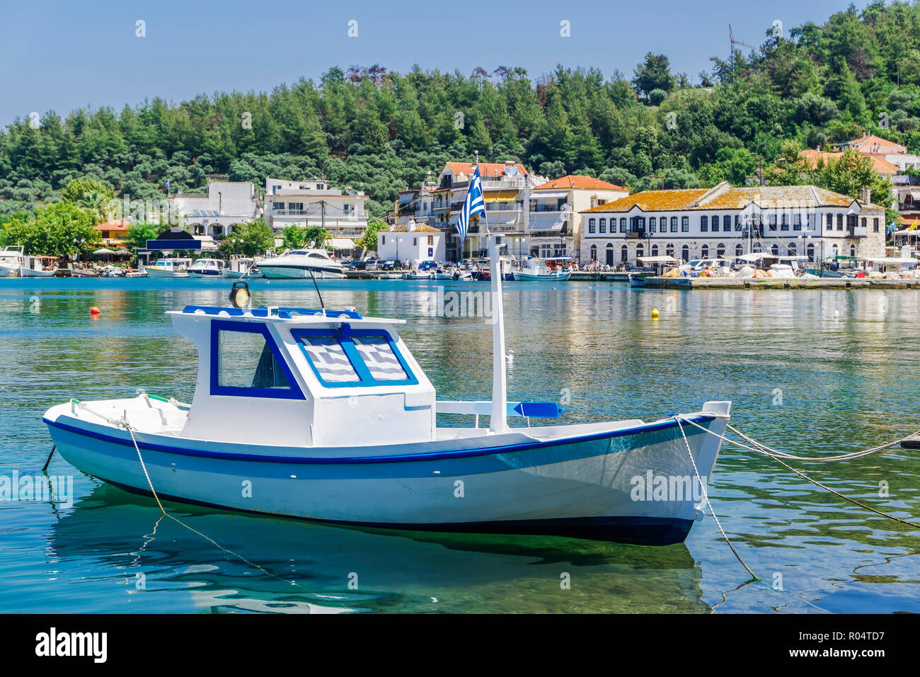 Moored small white boat with Greek flags, Limenas Town, Thassos island ...