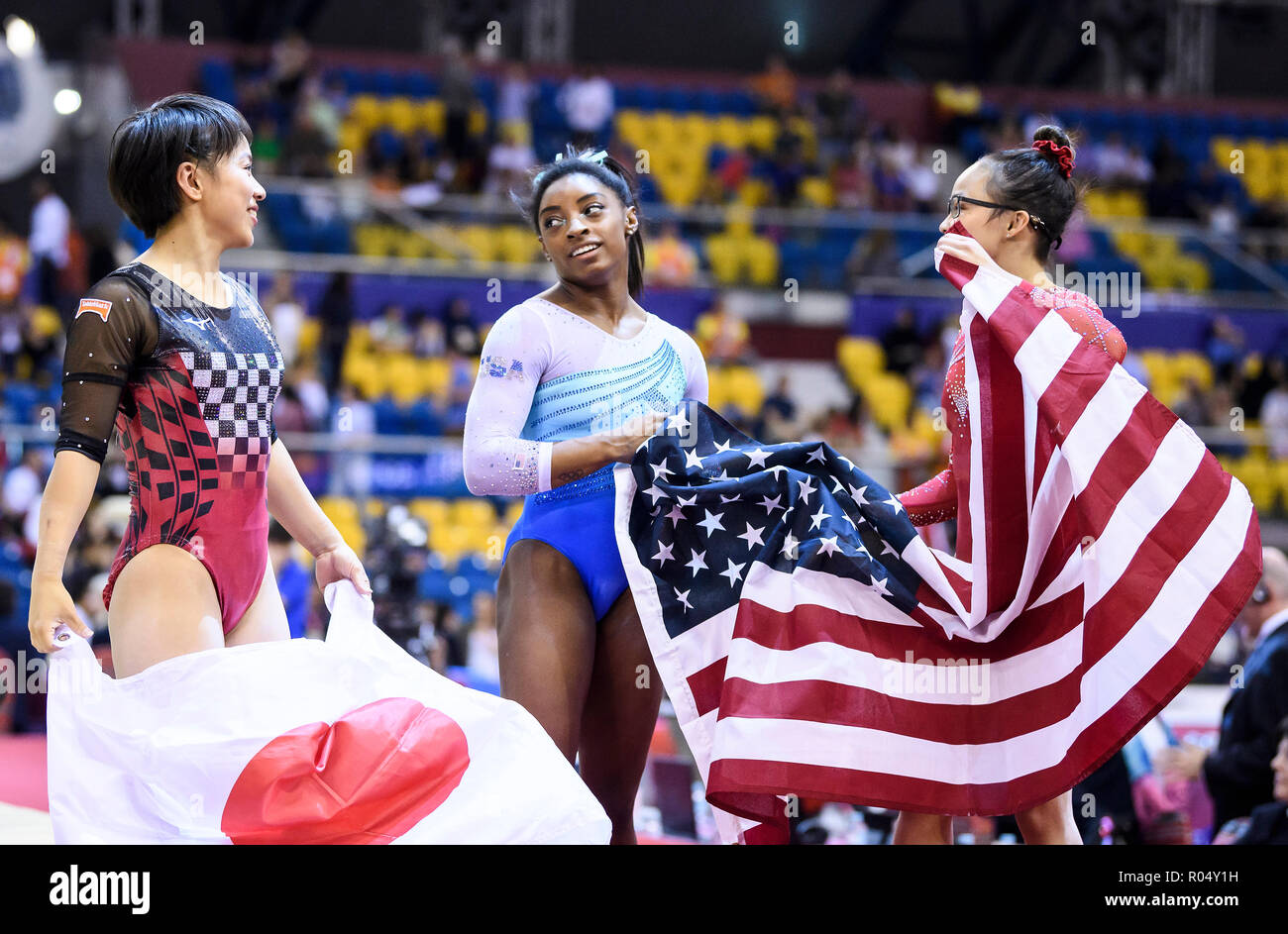 May Murakami (JPN), Simone Biles (USA) and Morgan Hurd (USA) with flag ...
