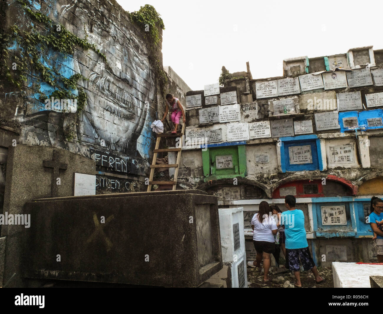 A woman going down using a wooden ladder to visit her deceased relative ...