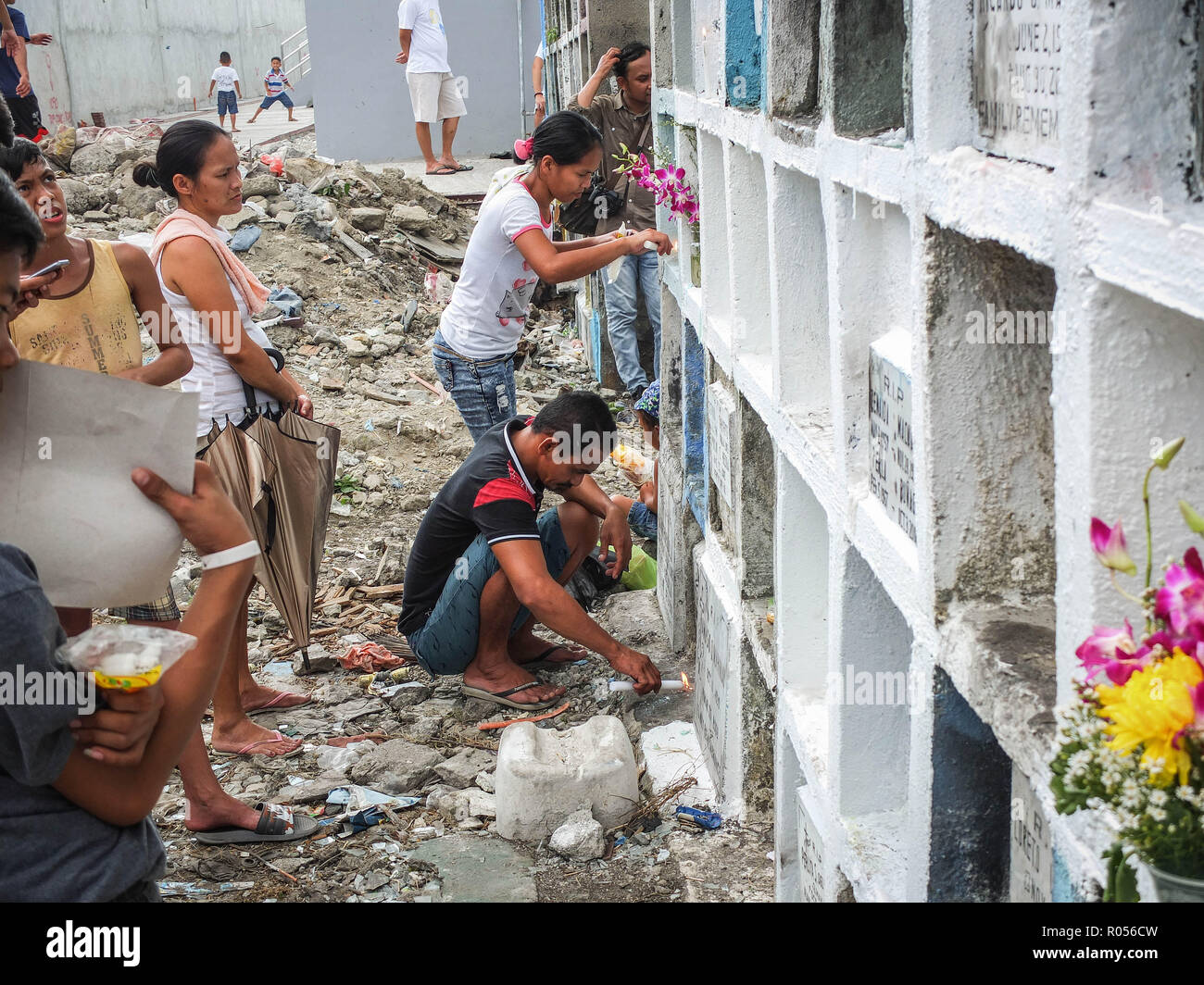 Filipinos paying respects to their departed love one by offering ...