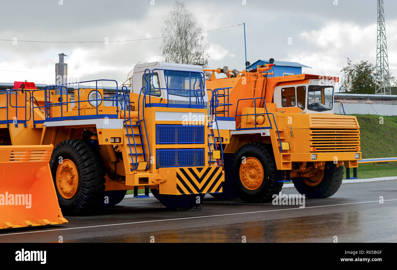 View of the parking lot of an exhibition of large mining trucks. Career ...