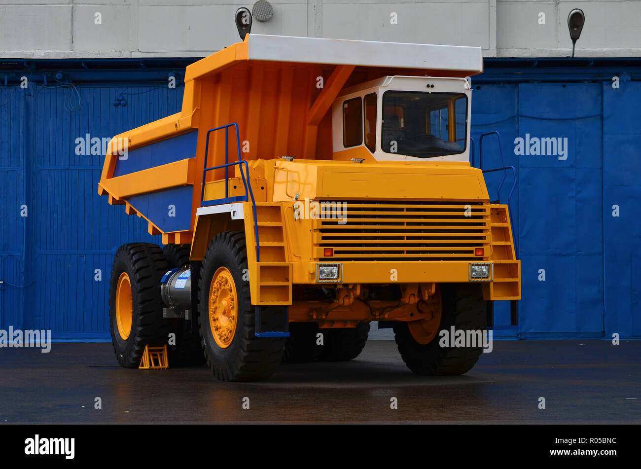 Yellow mid-class mining truck for the work on the transport of sand and ...