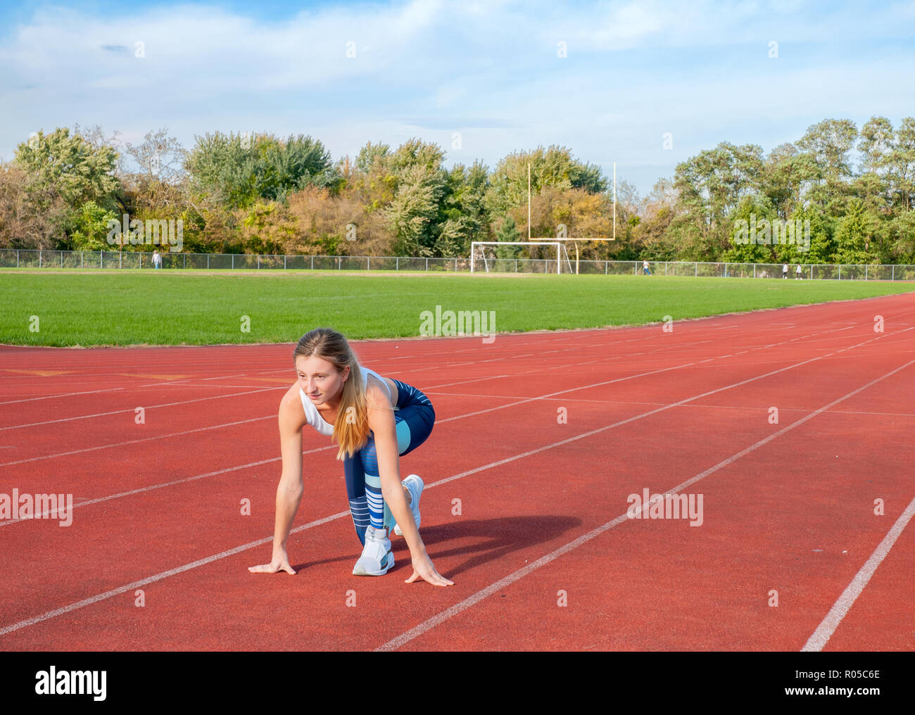 Beautiful woman ready to start running on runway Stock Photo - Alamy