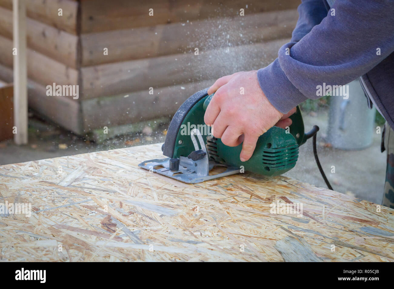 Circular saw cut off part of the Board on the street Stock Photo - Alamy