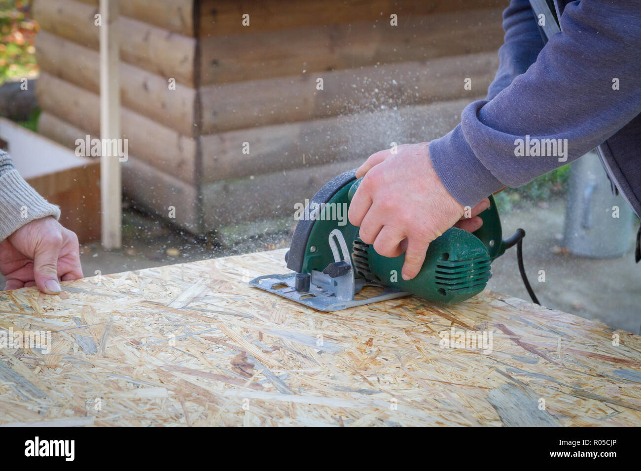 Circular saw cut off part of the Board on the street Stock Photo - Alamy