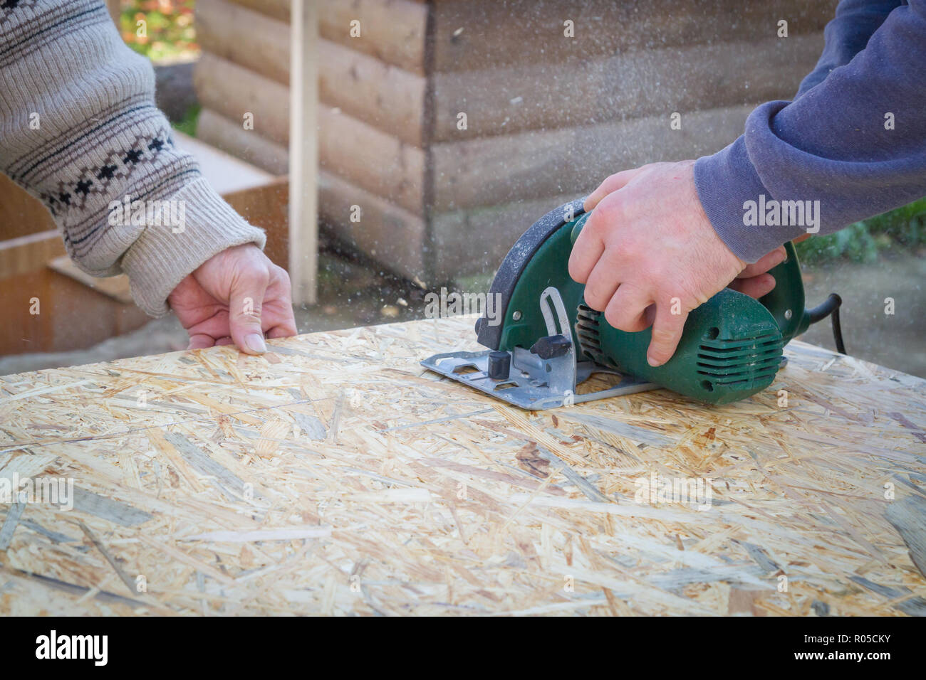 Circular saw cut off part of the Board on the street Stock Photo - Alamy