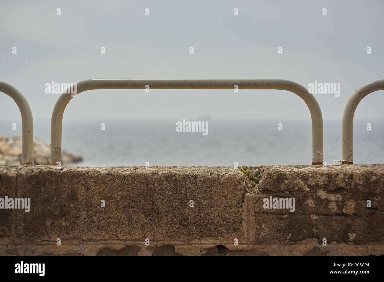 Detail of a concrete handrail with iron pipe used as a parapet on the ...