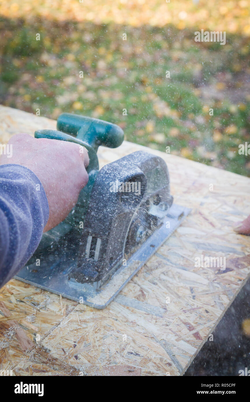 Circular saw cut off part of the Board on the street Stock Photo - Alamy