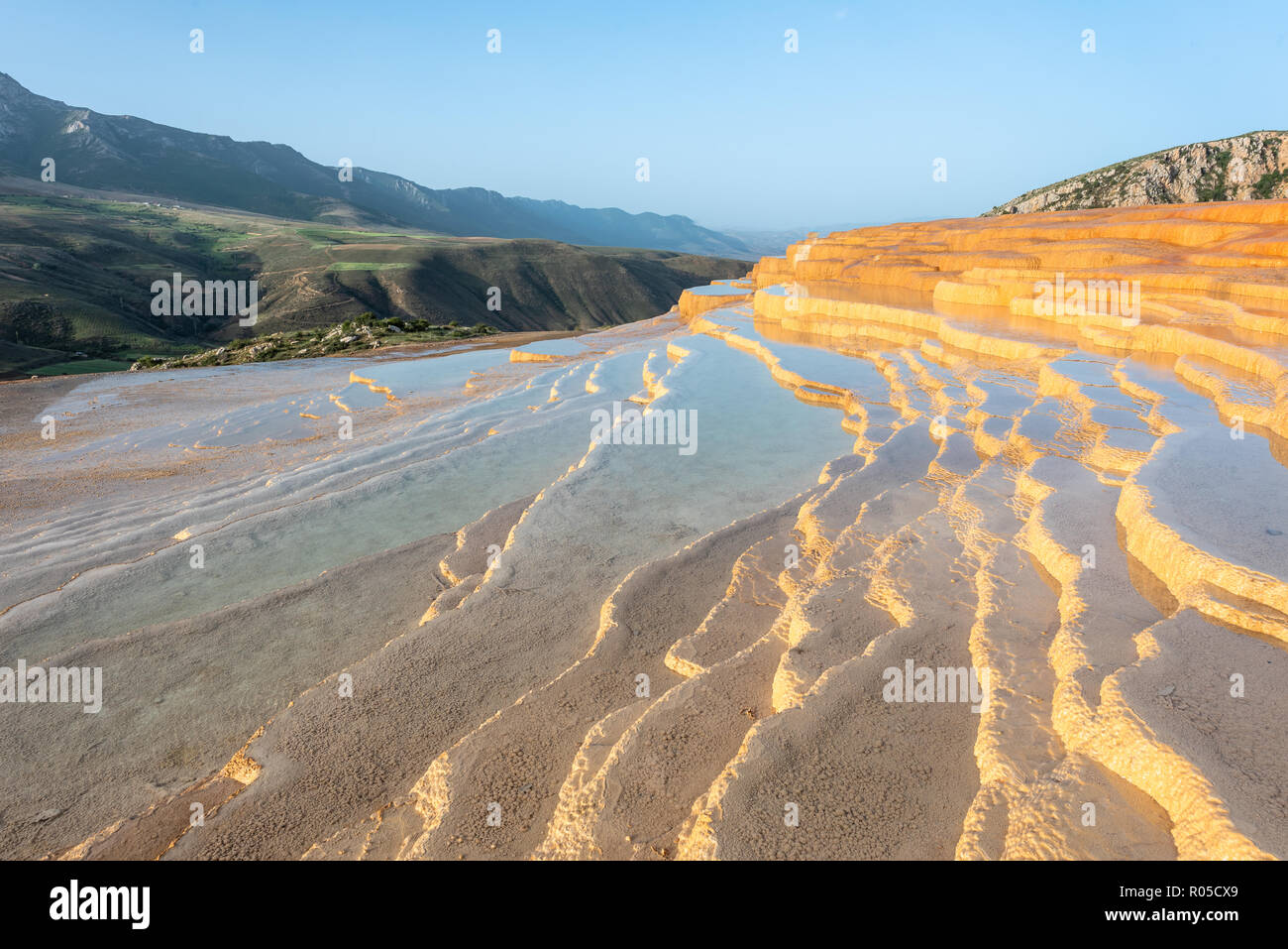 Travertine terrace at sunrise near Orost, one of the rare pure ...