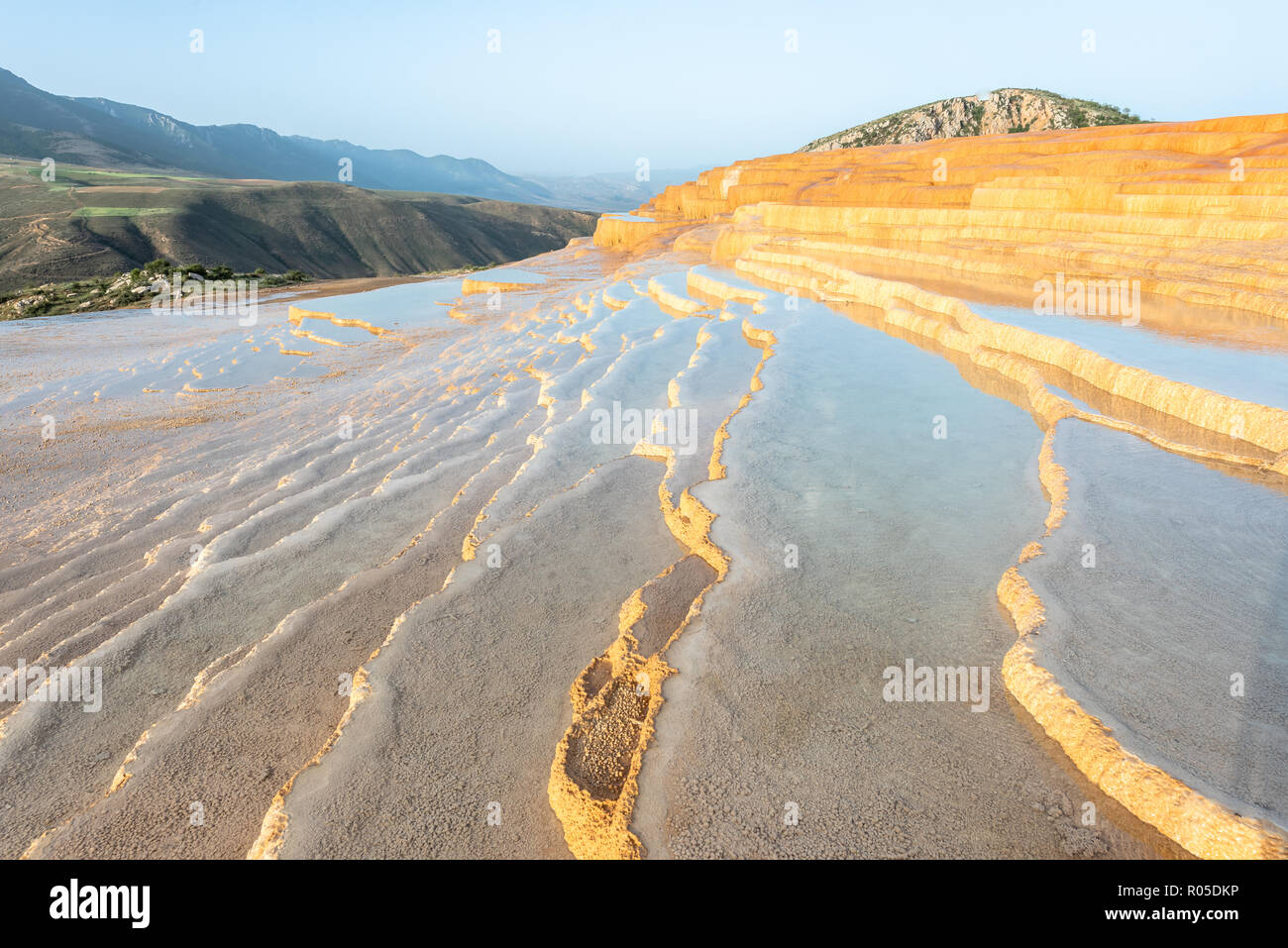Travertine terrace at sunrise near Orost, one of the rare pure ...