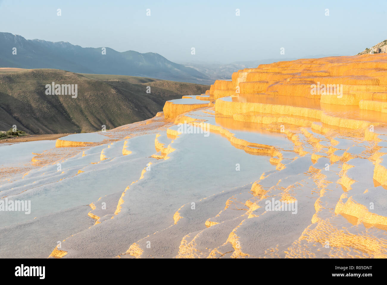 Travertine terrace at sunrise near Orost, one of the rare pure ...