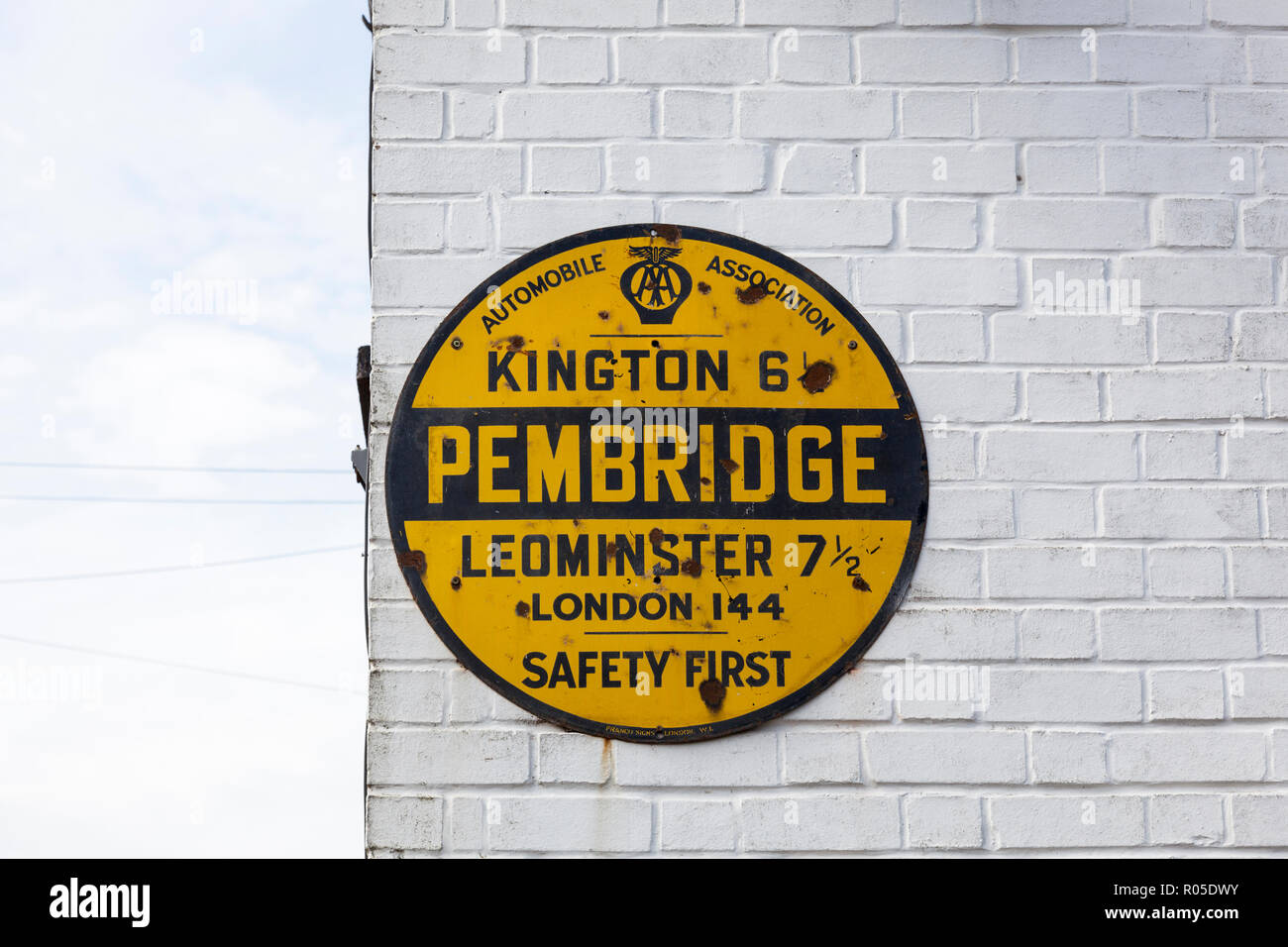 Old black and yellow AA wall sign detailing mileage from Pembridge to ...