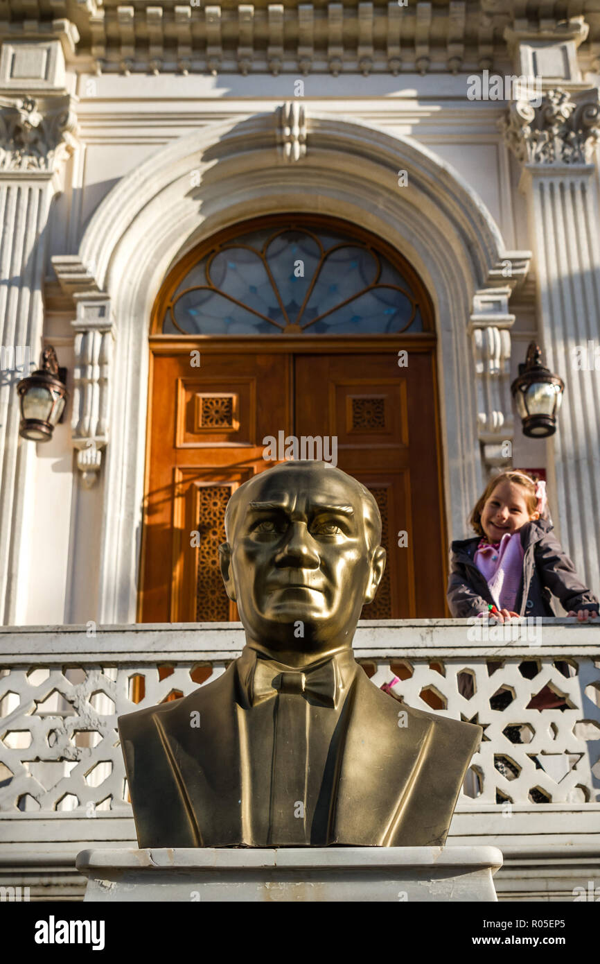 Happy cute little girl is smiling behind an Ataturk bust Stock Photo ...