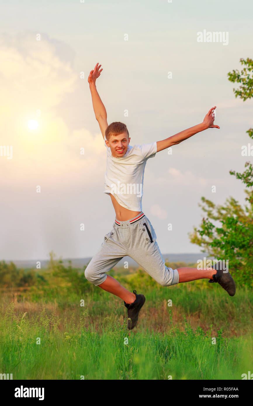 happy young man jumping in up on nature Stock Photo - Alamy