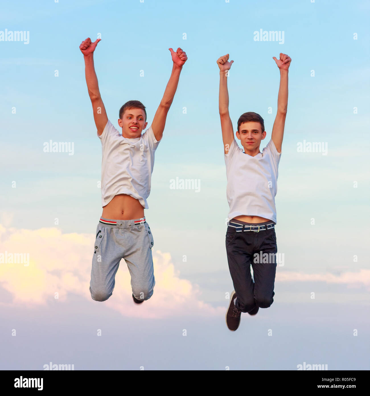 two happy young men jumping up on the nature Stock Photo - Alamy
