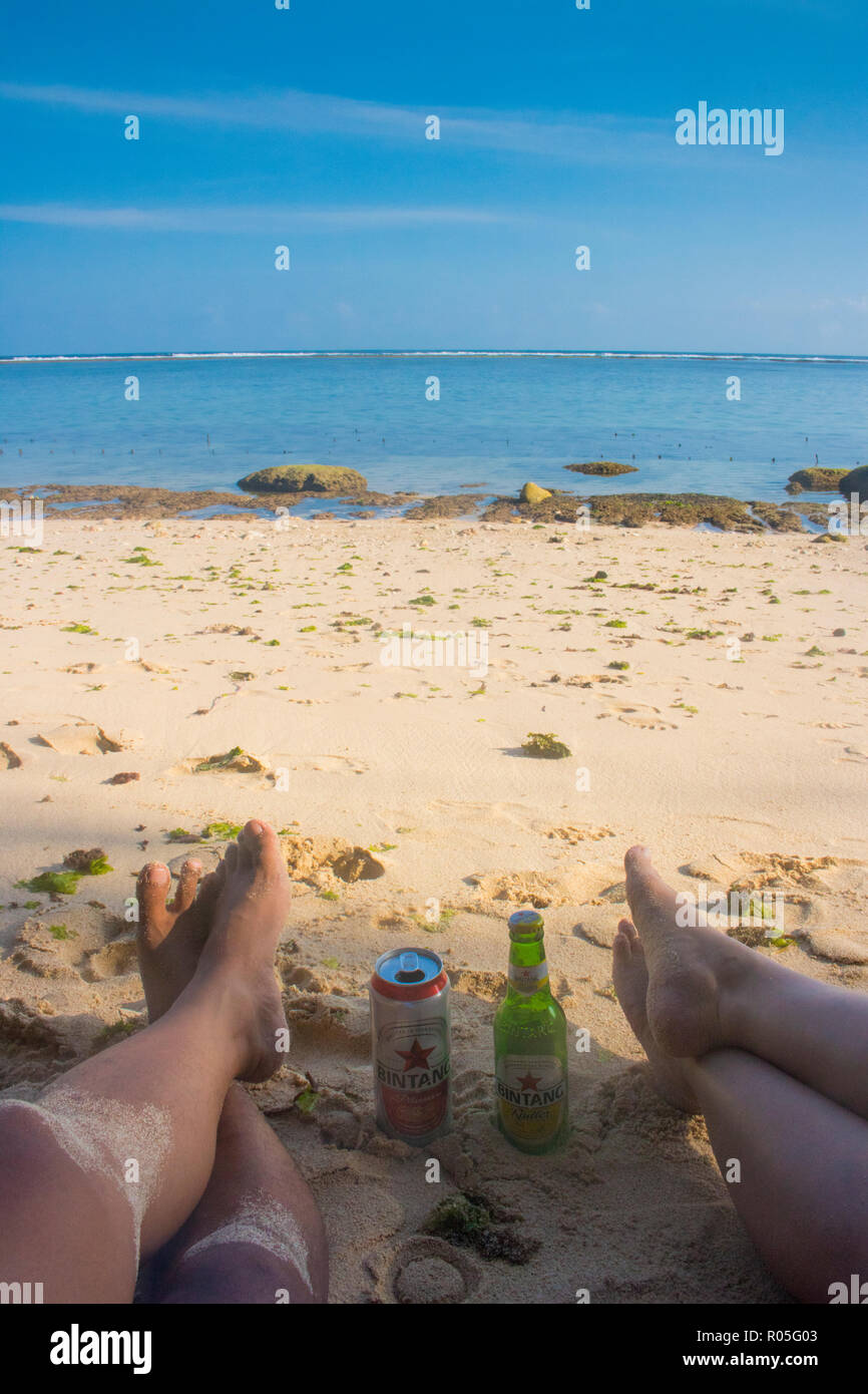 summer holiday beach theme beer with feet on beach Stock Photo - Alamy