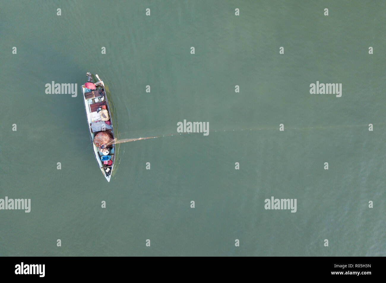 An aerial top angle view drone camera of coastal fisherman netting at ...
