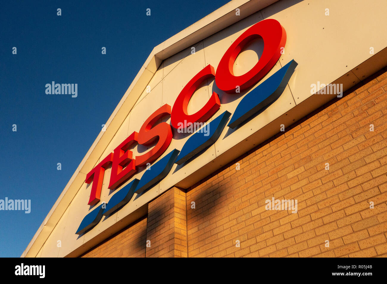 Exterior of Tesco and brand name Sign at sunset in Dinnington ...