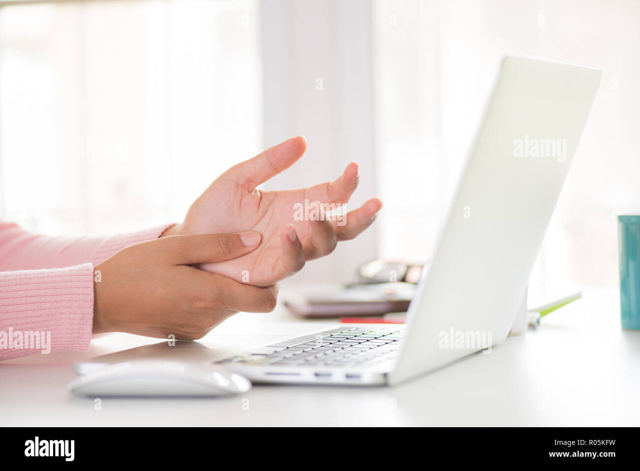 Closeup woman holding her wrist pain from using computer. Office ...