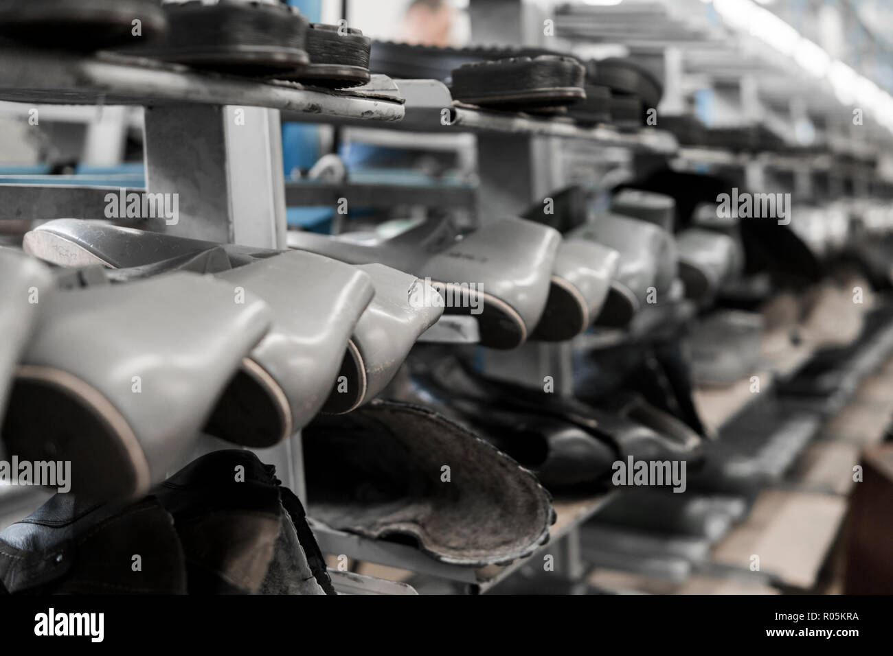 The conveyor on a shoes factory with shoe and sole. Mass production of ...