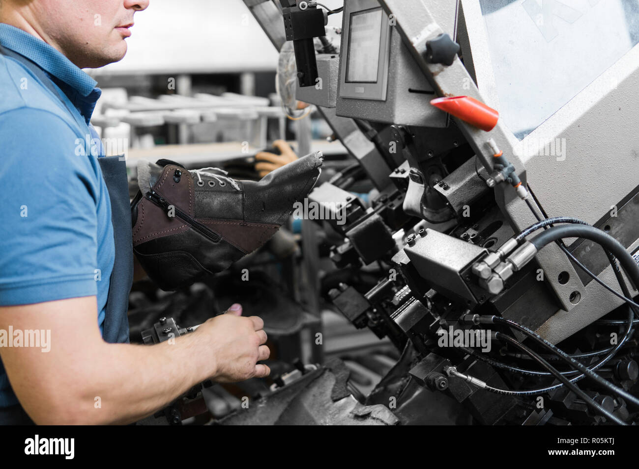 Man use special machine tool for making a shoes. The conveyor on a ...