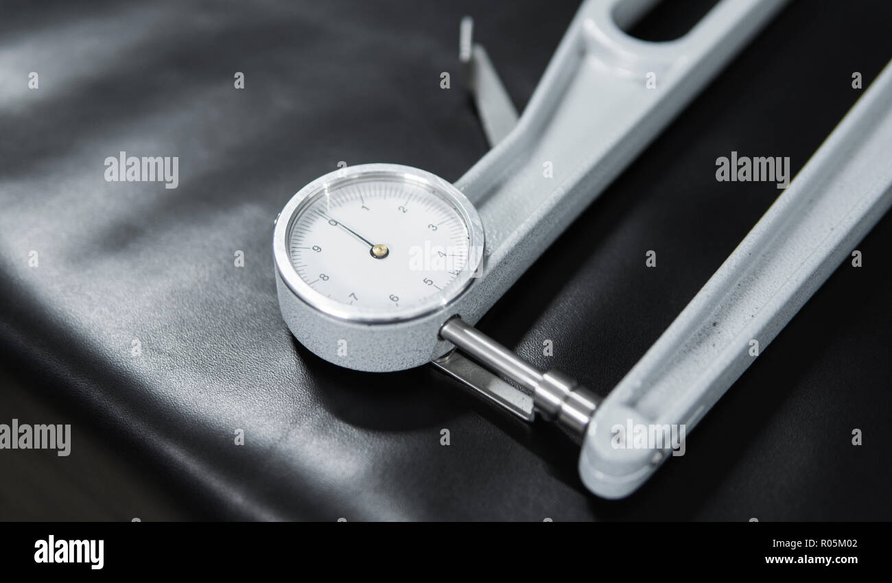 Leather thickness gauge on natural black leather. Preparing of the raw ...