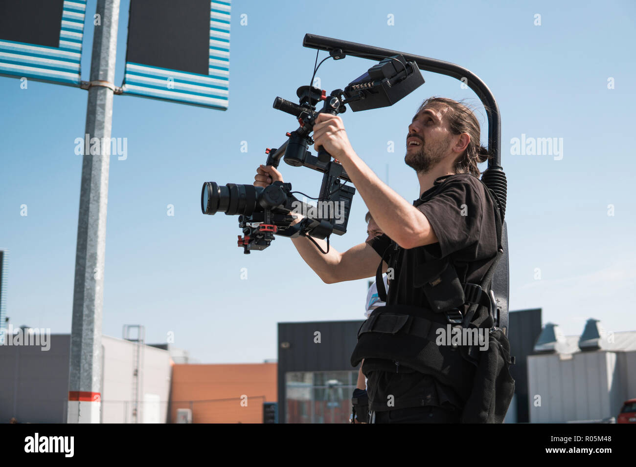 Professional videographer holding camera on 3-axis gimbal which mounted ...