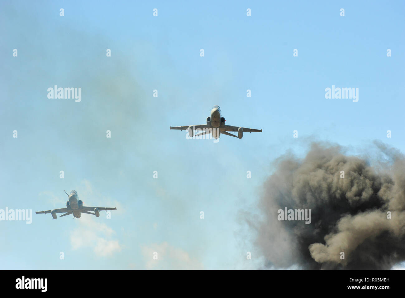 Two jet fighter aircarft seen in between smoke and fire after bombing ...
