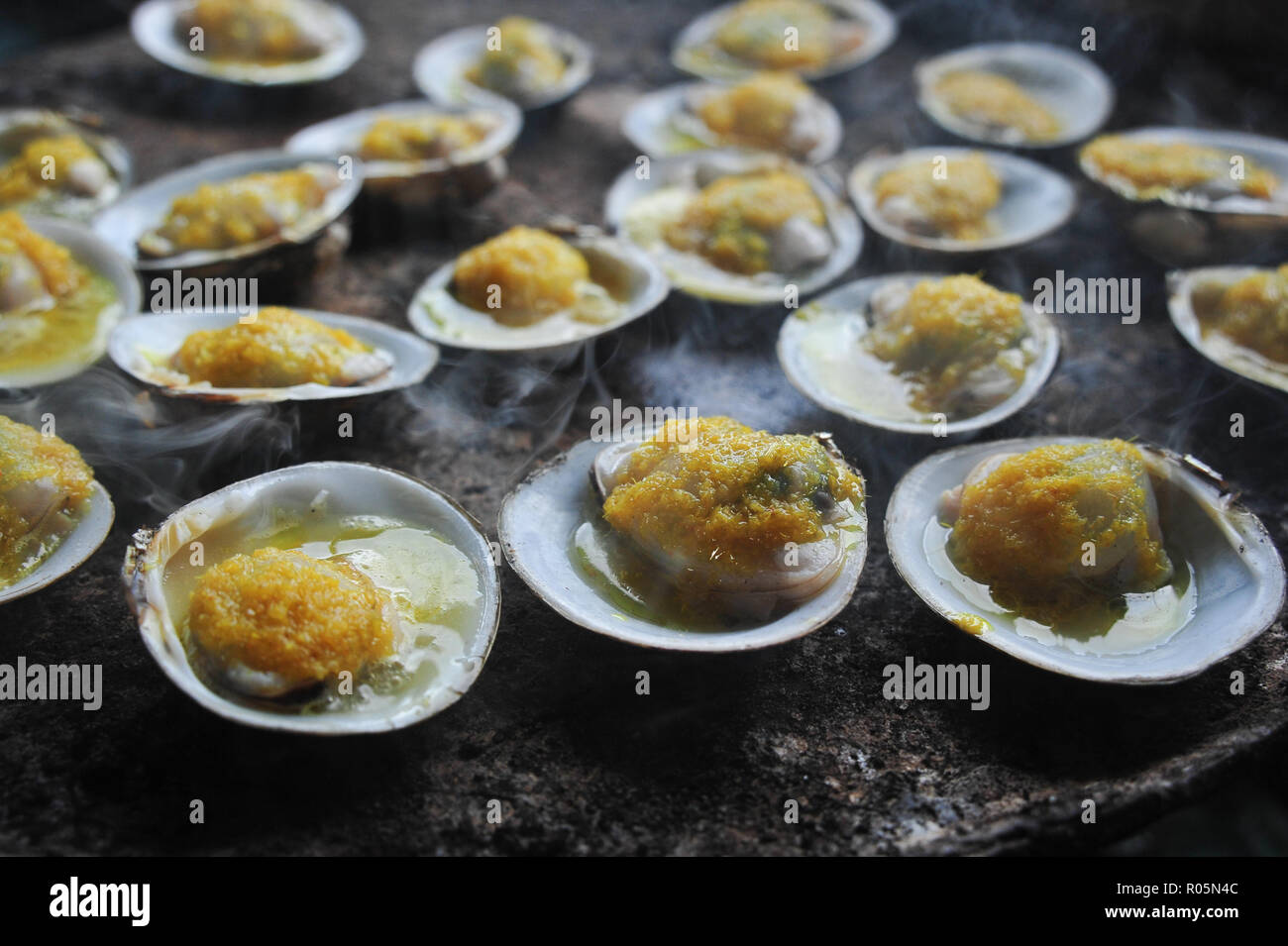 Delicious sea shell with spices grilled on fire using traditional ...