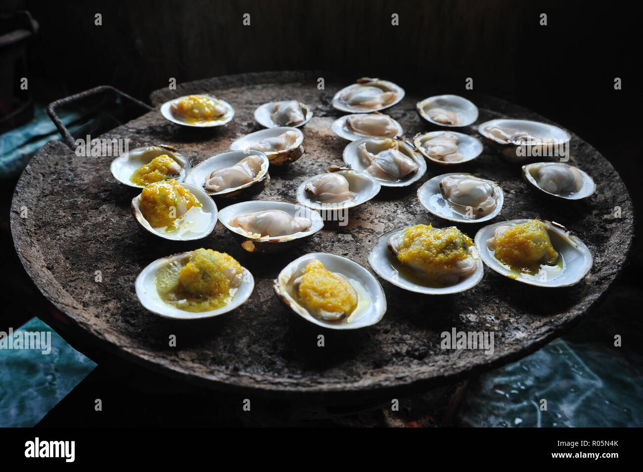 Delicious sea shell with spices grilled on fire using traditional ...