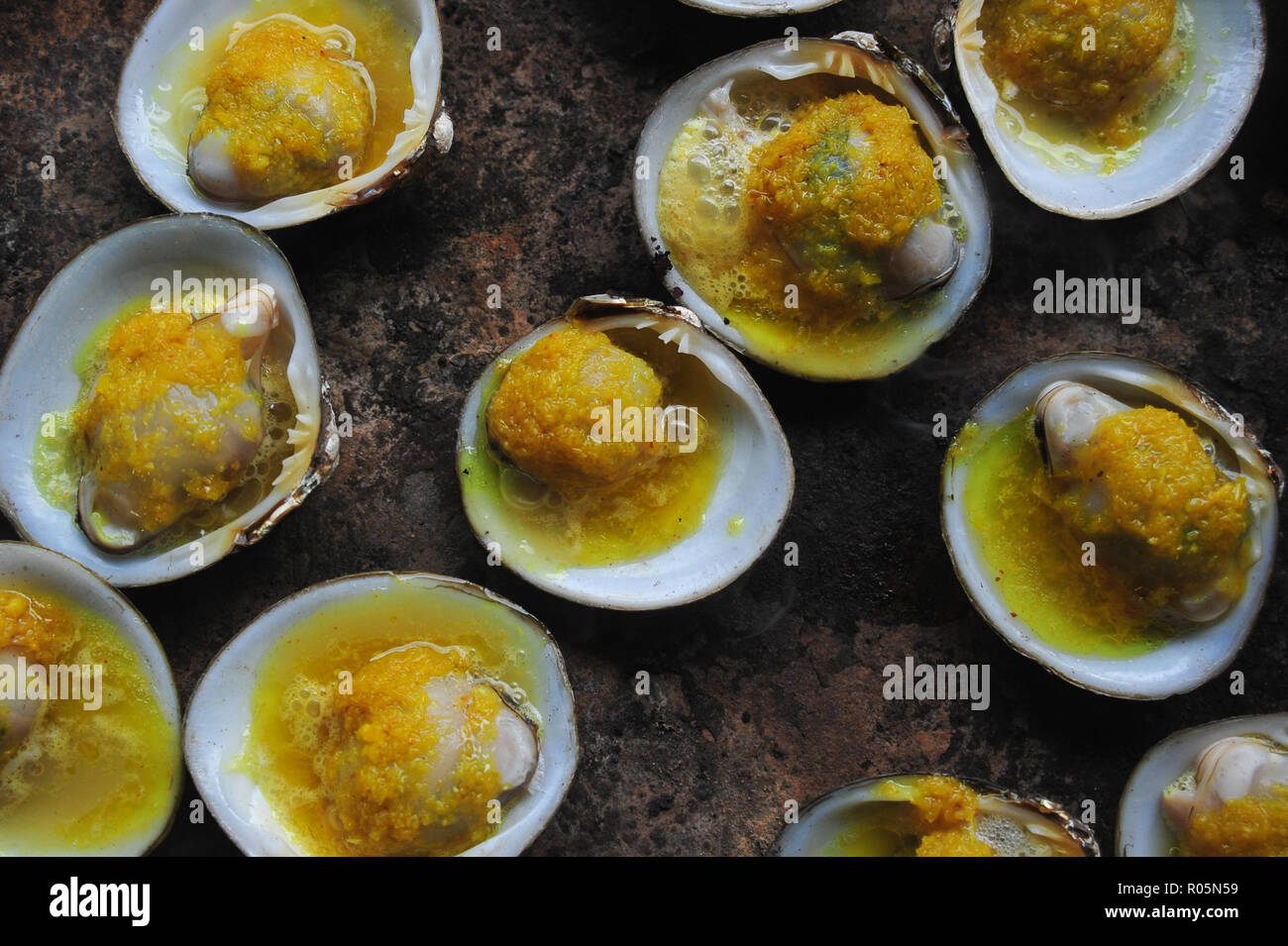 Delicious sea shell with spices grilled on fire using traditional ...