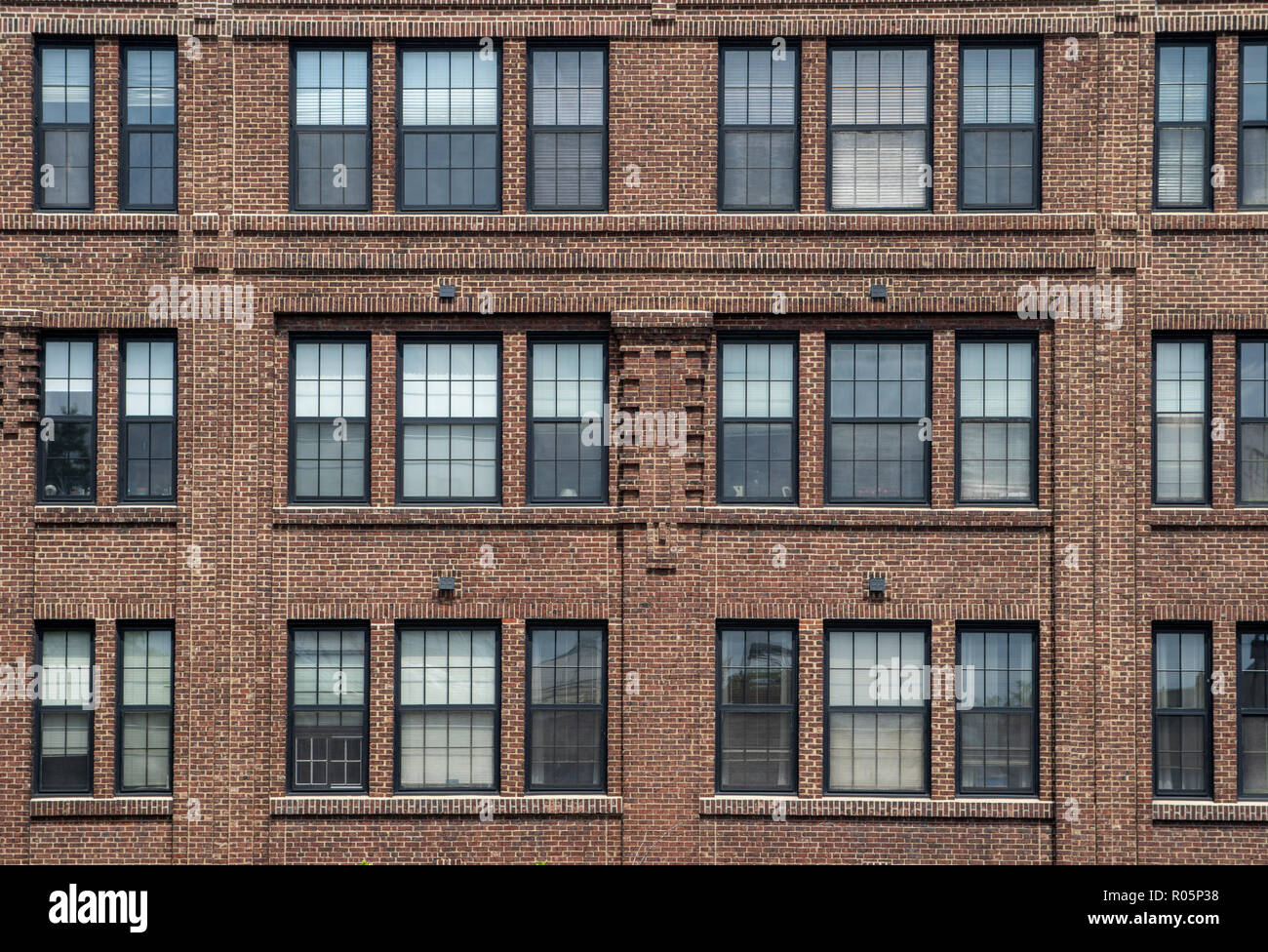 A brick wall filled with many windows Stock Photo - Alamy